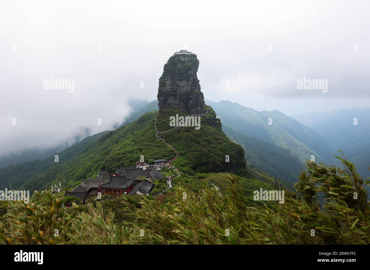 A view of a building on top of a rock of Fanjingshan Mountain in ...