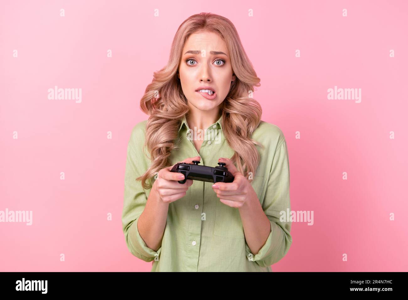 Photo of doubtful unsure lady wear green shirt loosing playstation game ...