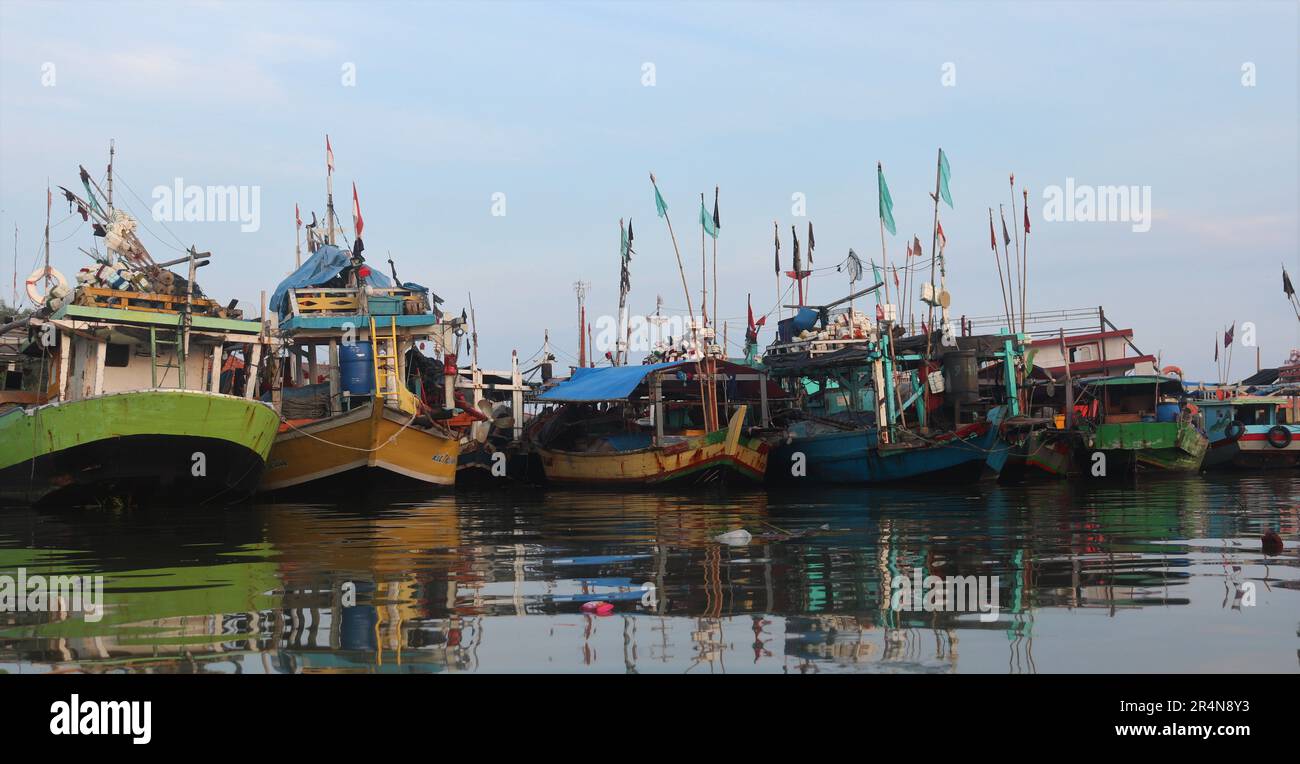 Colorful traditional fishing boats dock at the fishing port of ...