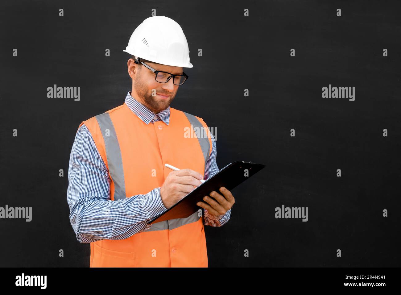 Male Engineer in a White Hard Hats and Orange West. Handsome Confident ...