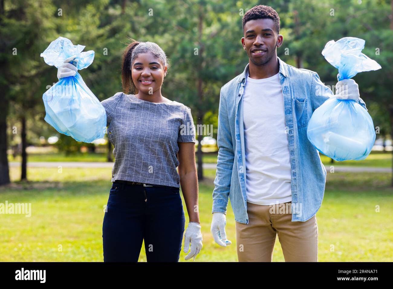 afro american volunteers collecting plastic trash at sunny day in ...