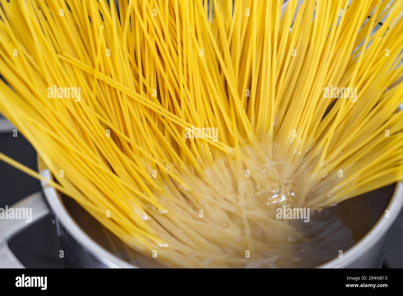 Yellow spaghetti boil in water hi-res stock photography and images - Alamy