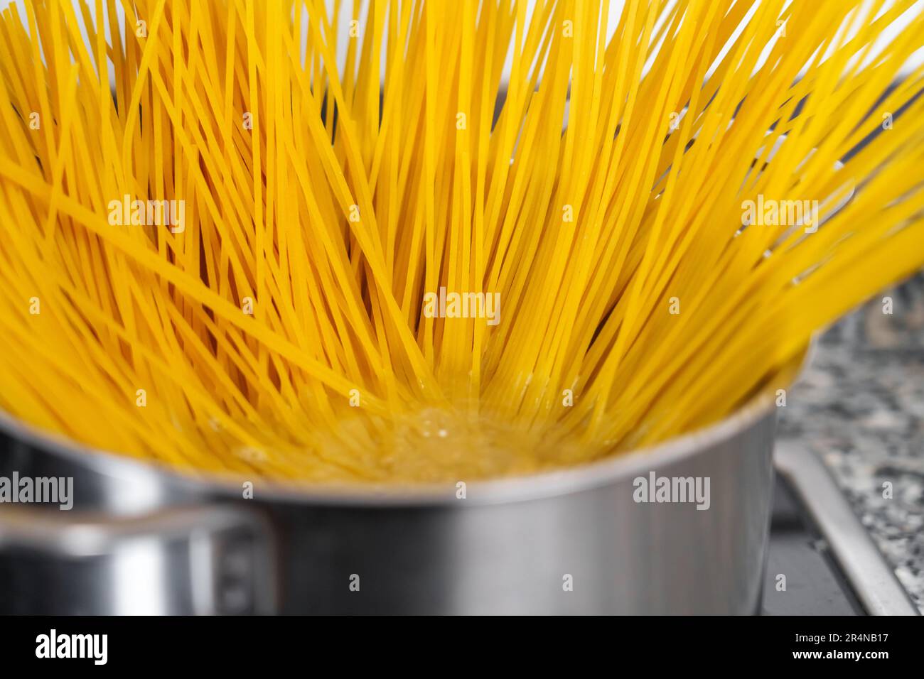 Spaghetti cooking in a pot of boiling water on an electric stove Stock ...