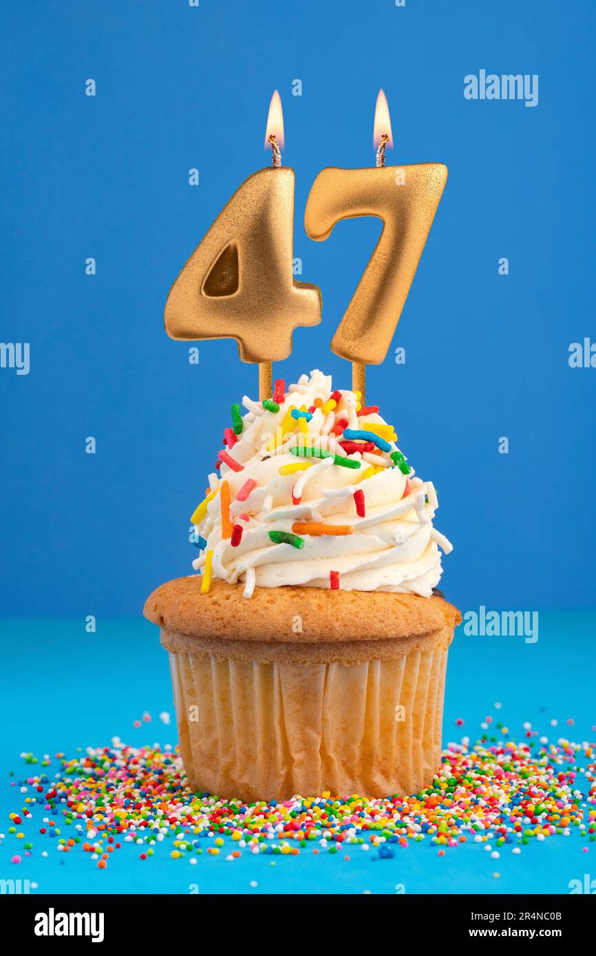 Candle number 47 - Cake birthday in blue background Stock Photo - Alamy