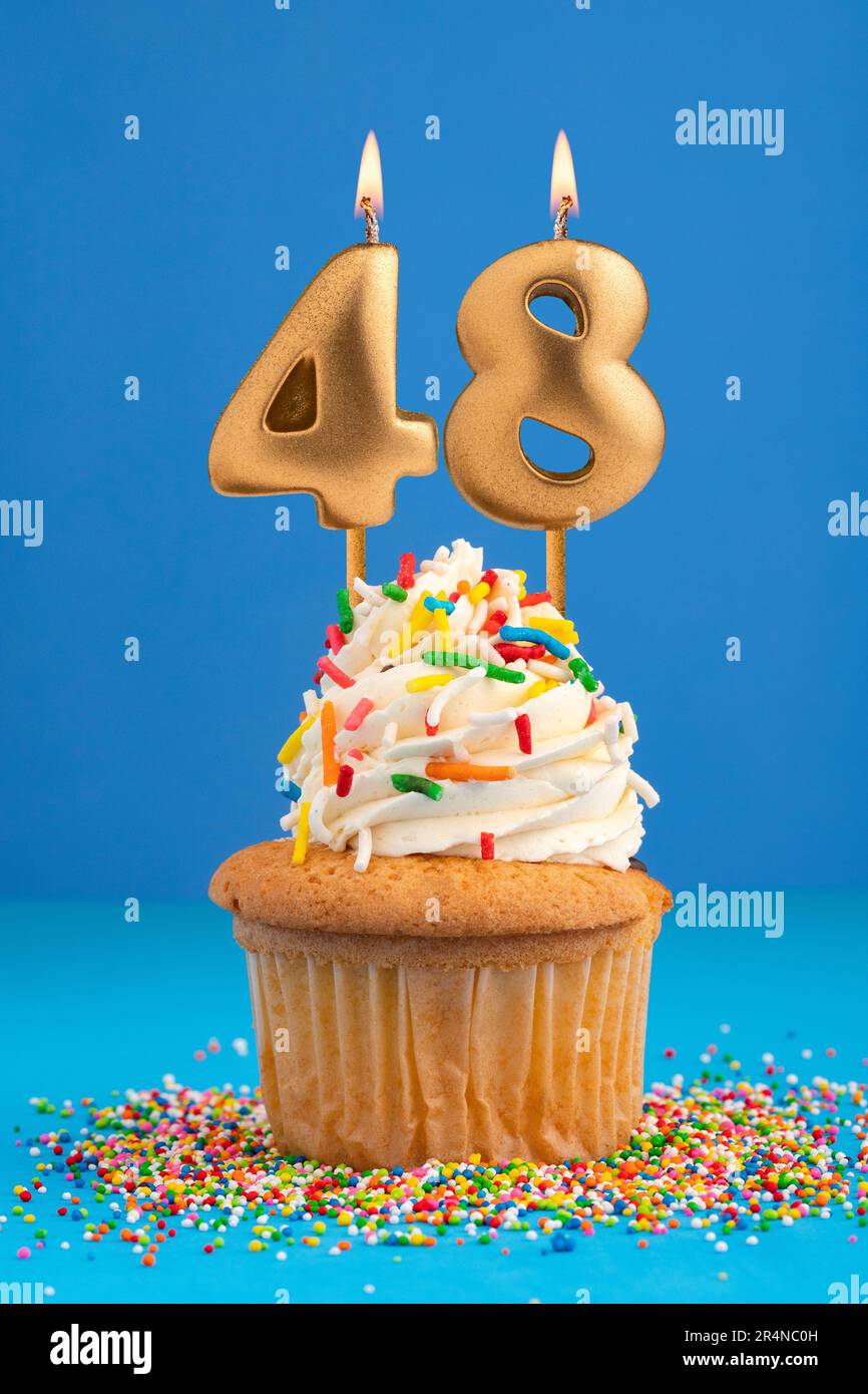 Birthday cake with candle number 48 - Blue background Stock Photo - Alamy