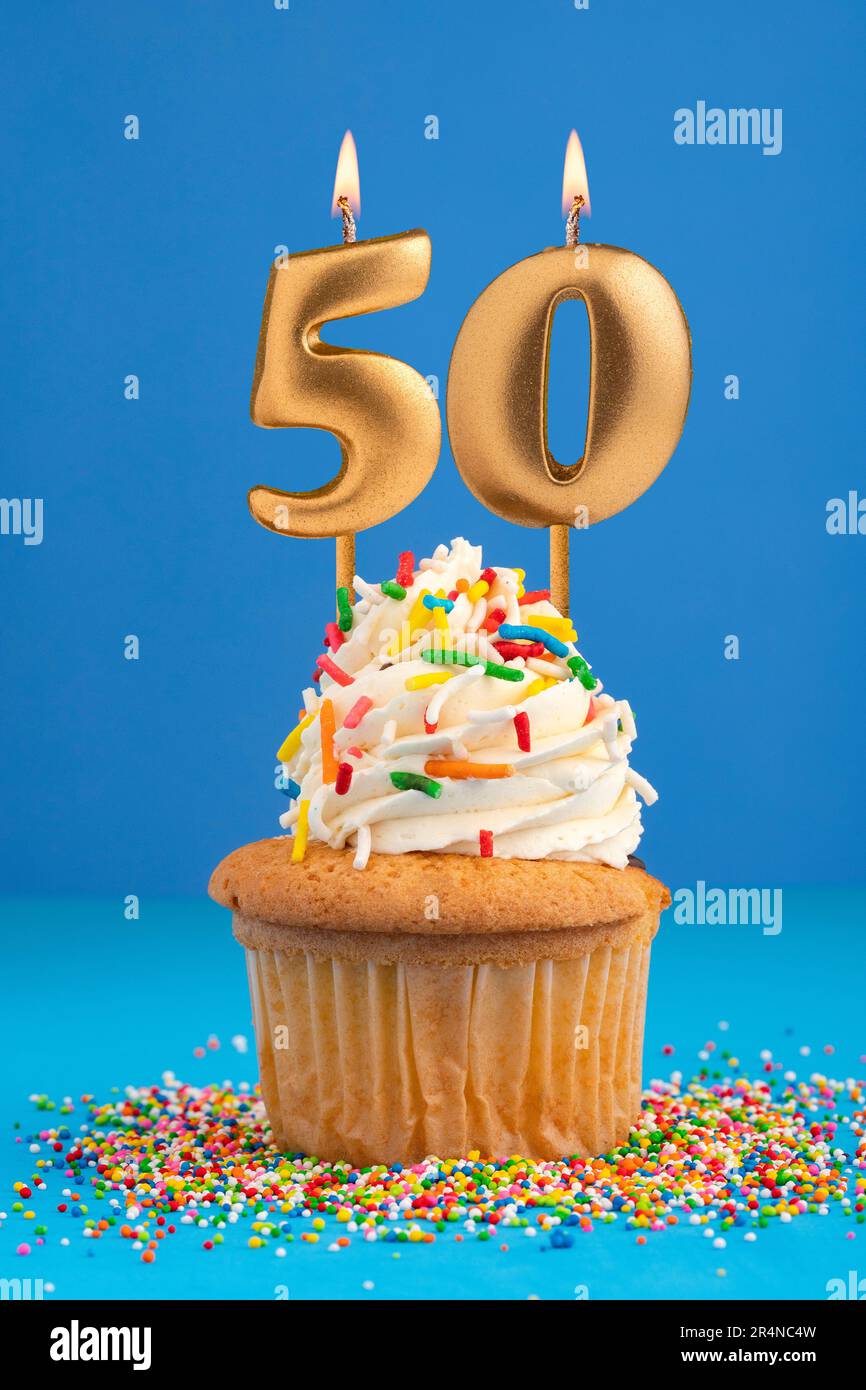 Birthday cake with candle number 50 - Blue background Stock Photo - Alamy
