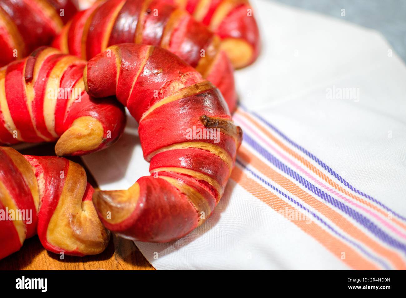 Freshly made Croissants and Cornettos pastries exposed on white cloth ...