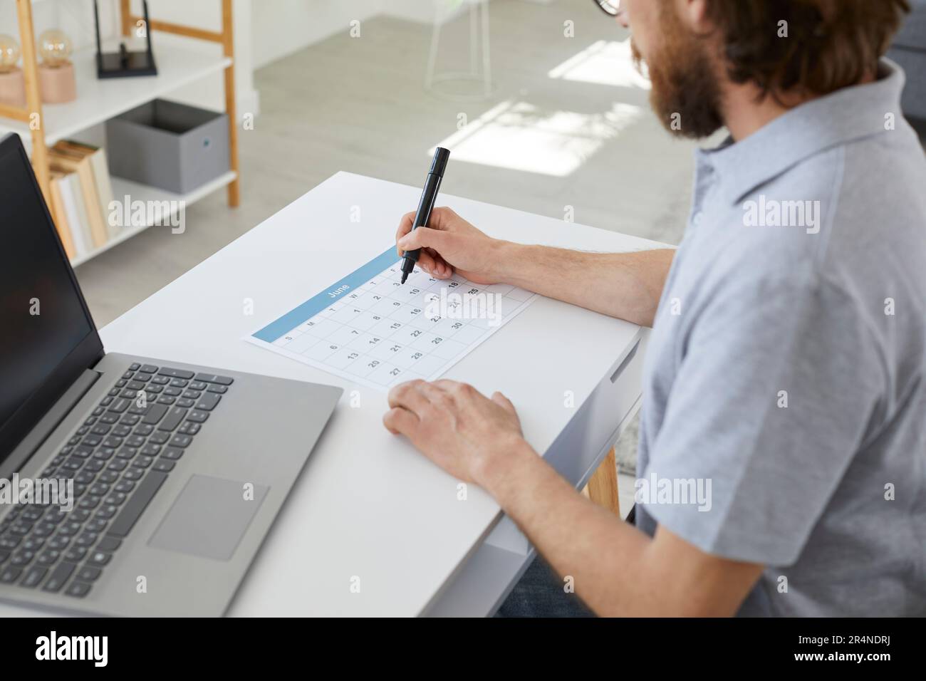 Man working in the office, planning his business schedule and marking ...