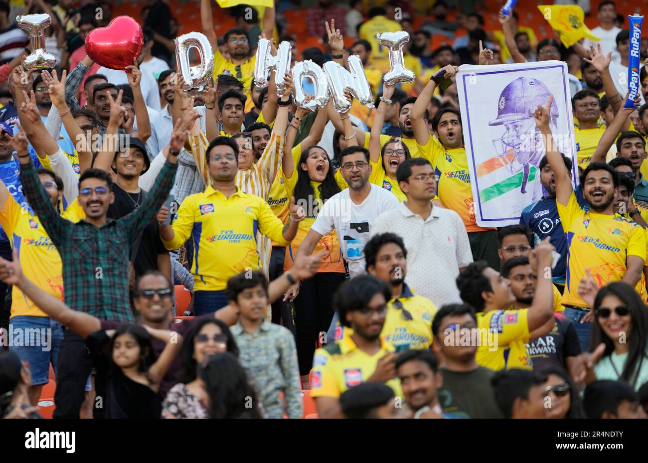 Chennai Super Kings fans cheer as their team warms up before the start of the Indian Premier ...