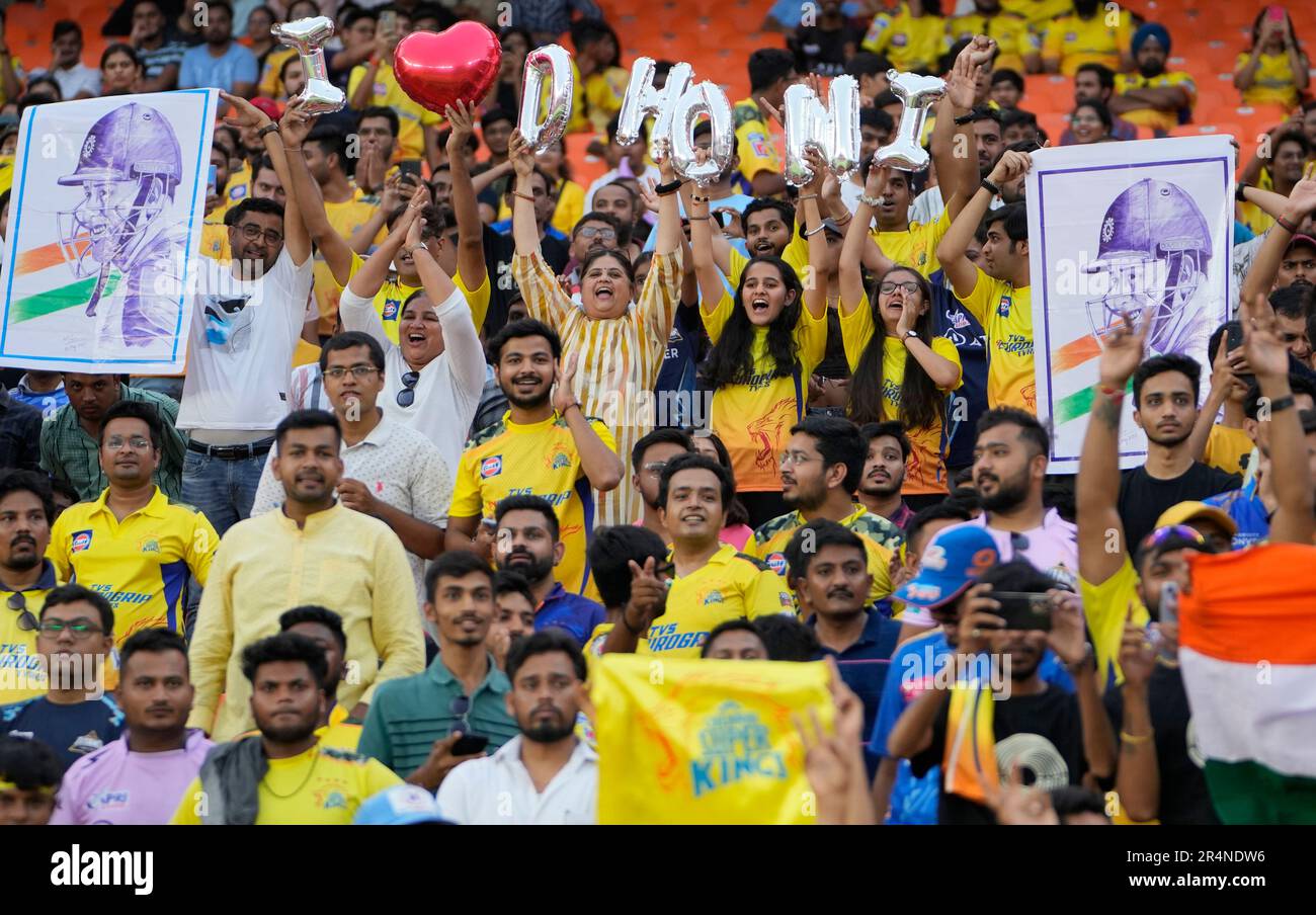 Chennai Super Kings fans cheer as their team warms up before the start of the Indian Premier ...