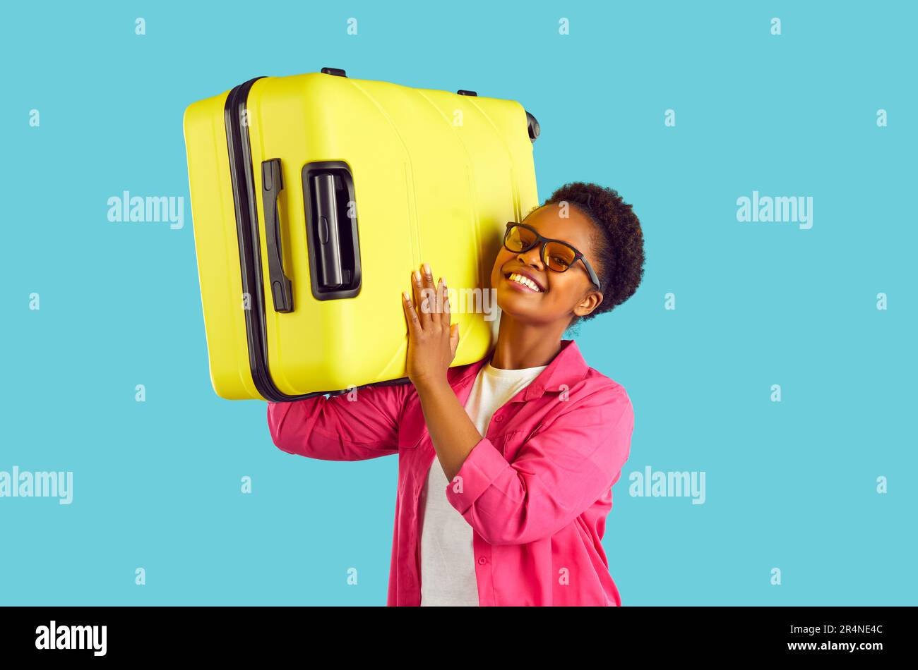 Young african american woman with pretty smile carrying her yellow ...
