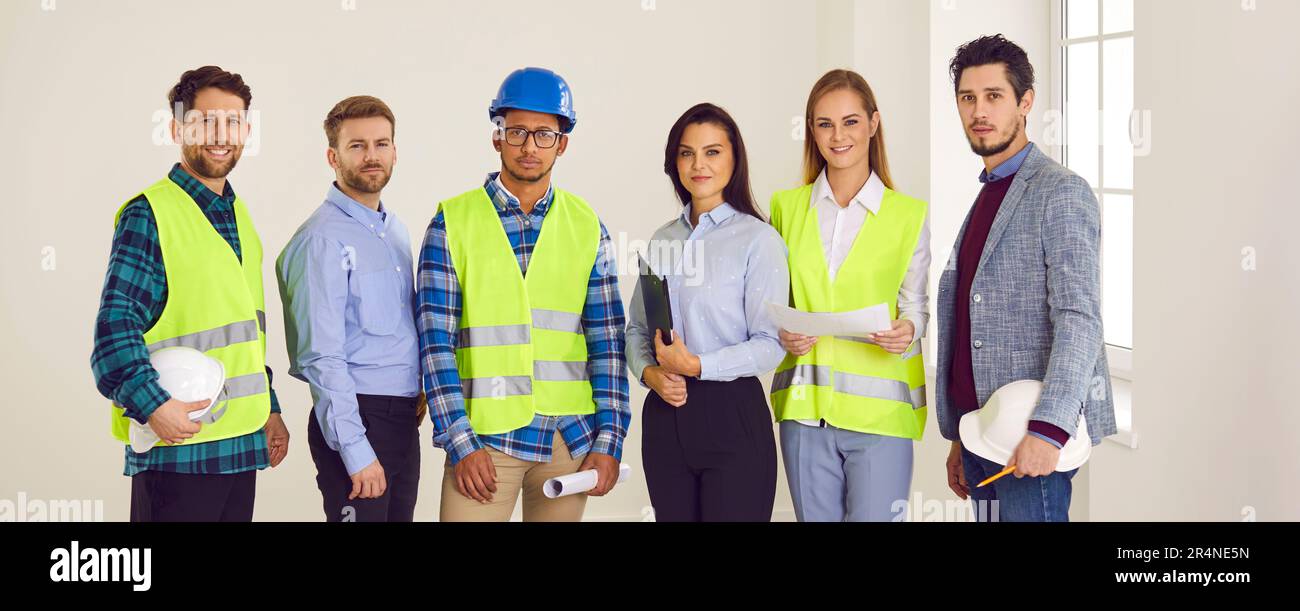 Portrait smiling architects blueprint hi-res stock photography and ...