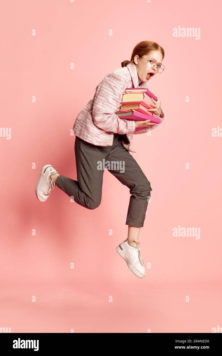 Crazy girl, busy student with red hair wearing uniform, holding books ...
