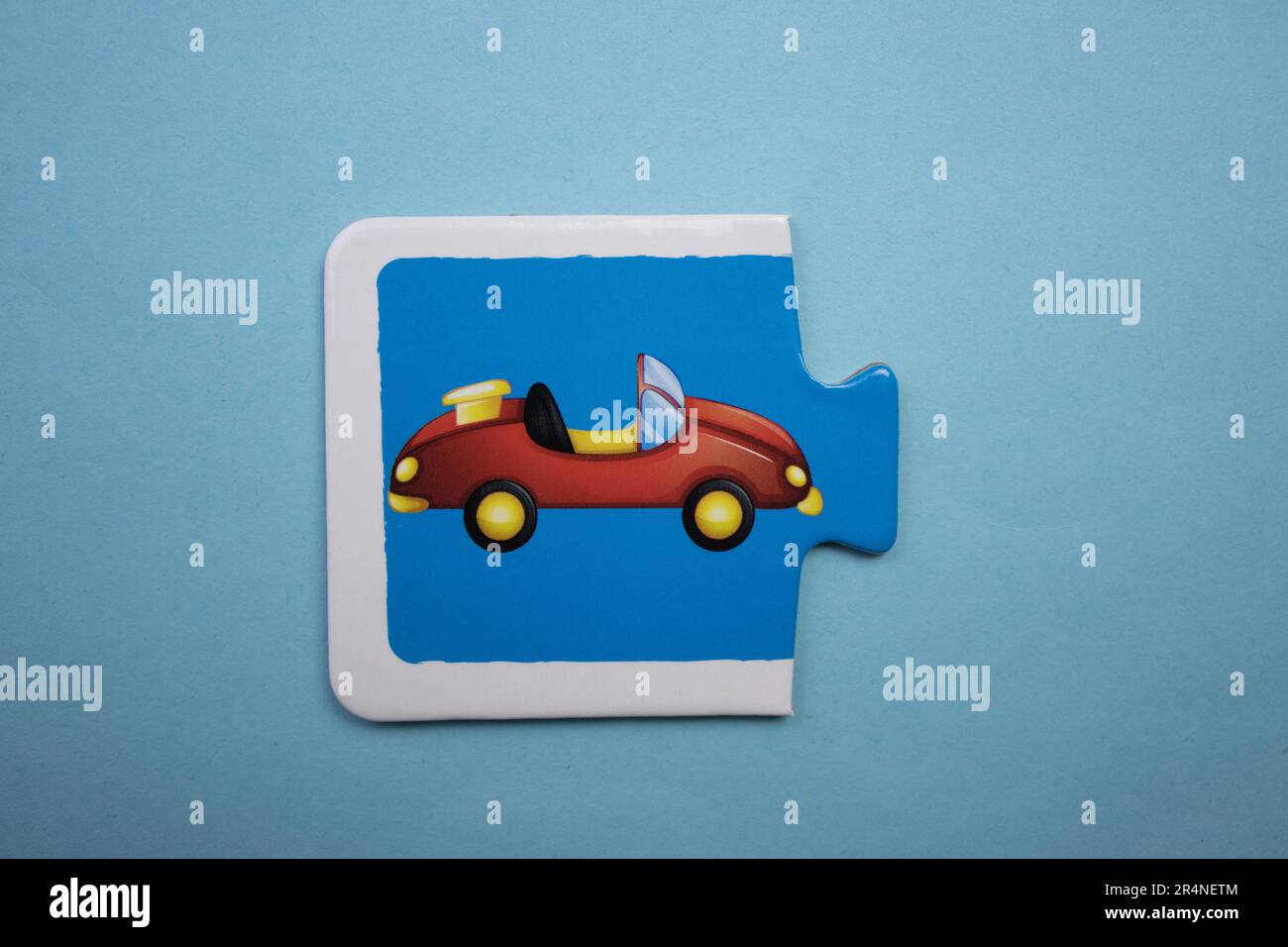 Picture puzzles placed on a blue background. Red car Stock Photo - Alamy
