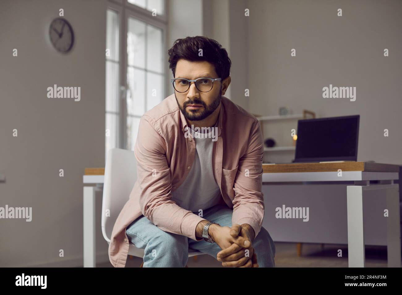 Portrait of serious and confident male freelancer who poses in his ...
