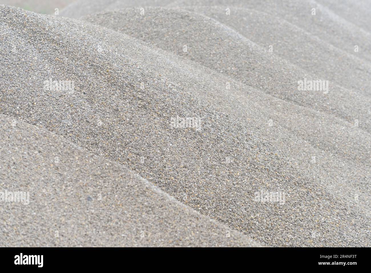 Large pile of gray gravel stone as road construction material as ...
