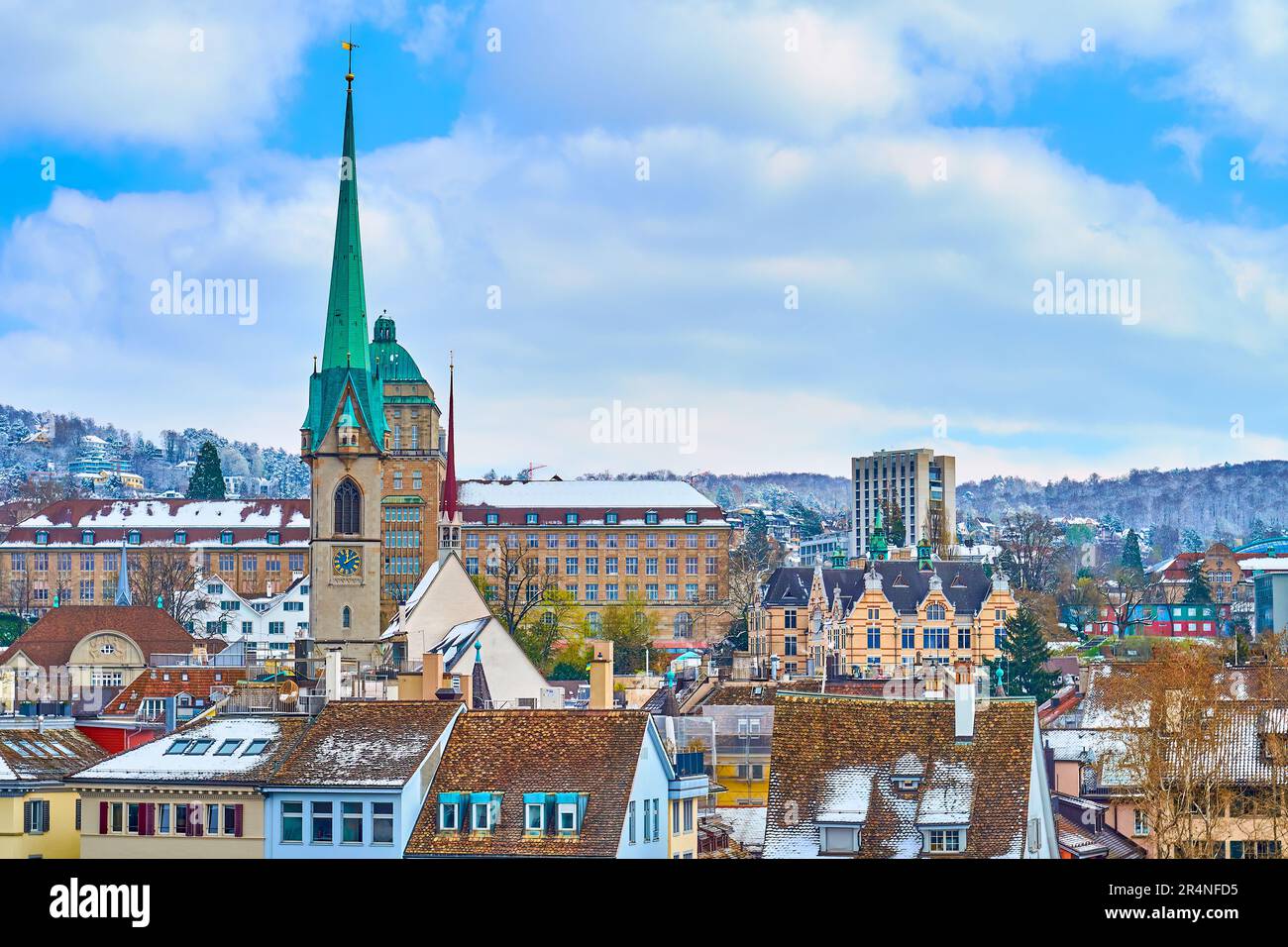 The high spire of Predigerkirche church rises above the roofs of ...