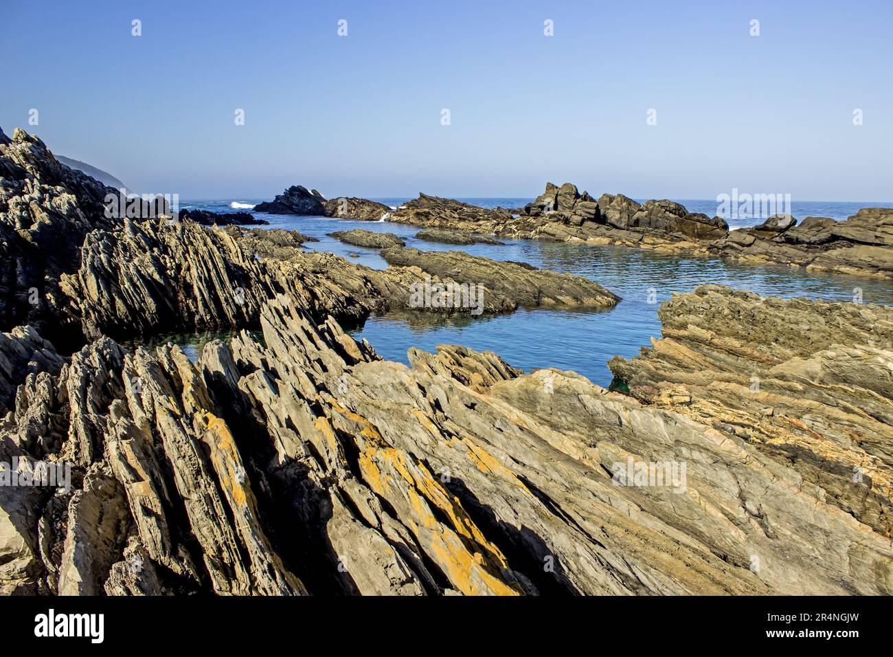 Looking along the tilted, Jagged Rocky Coastline of the Tsitsikamma ...