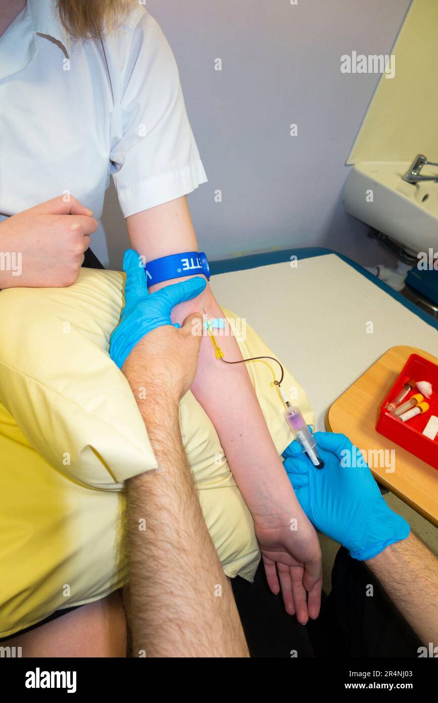 Blood test being performed on a young teenage girl / girls arm / blood ...