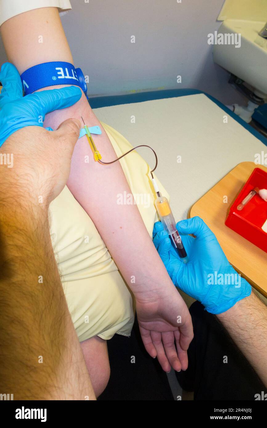 Blood test being performed on a young teenage girl / girls arm / blood ...