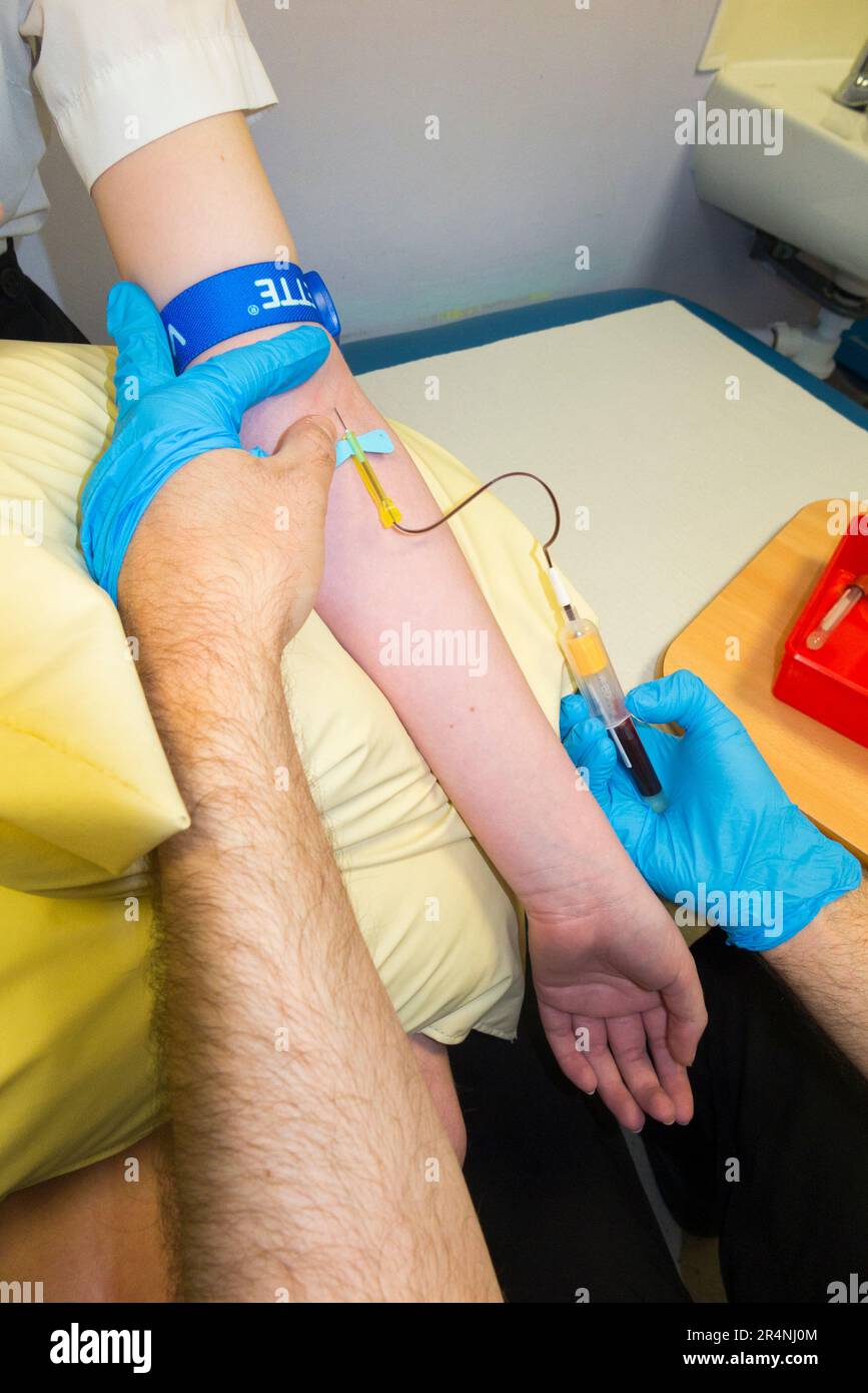 Blood test being performed on a young teenage girl / girls arm / blood ...