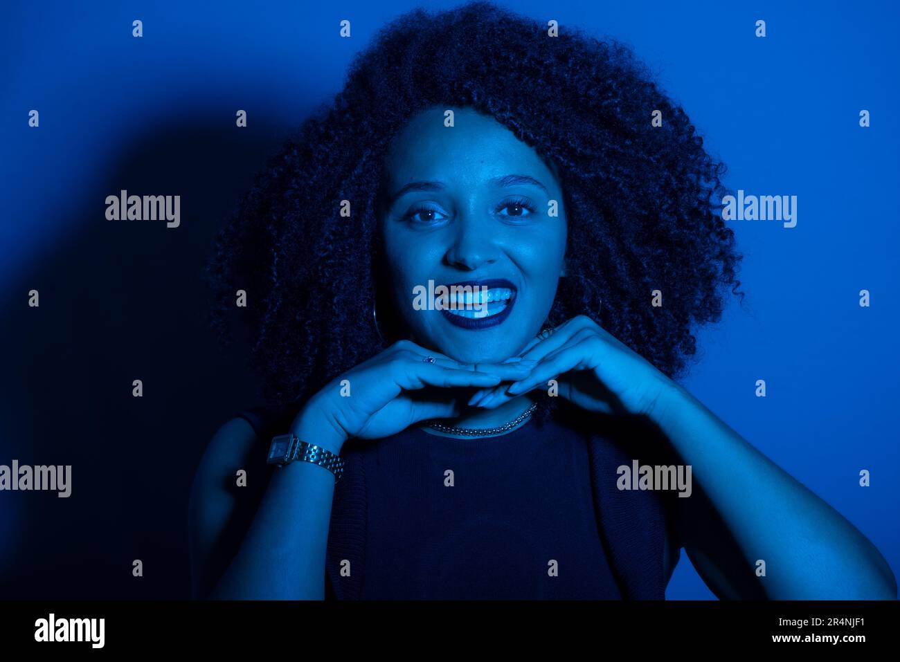 Close-up portrait of beautiful young woman making hand gestures ...