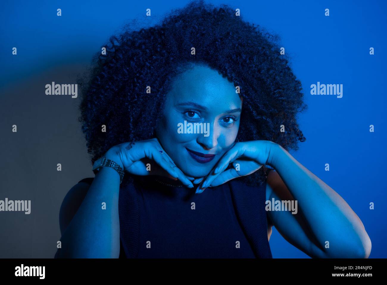 Close-up portrait of beautiful young woman making hand gestures ...