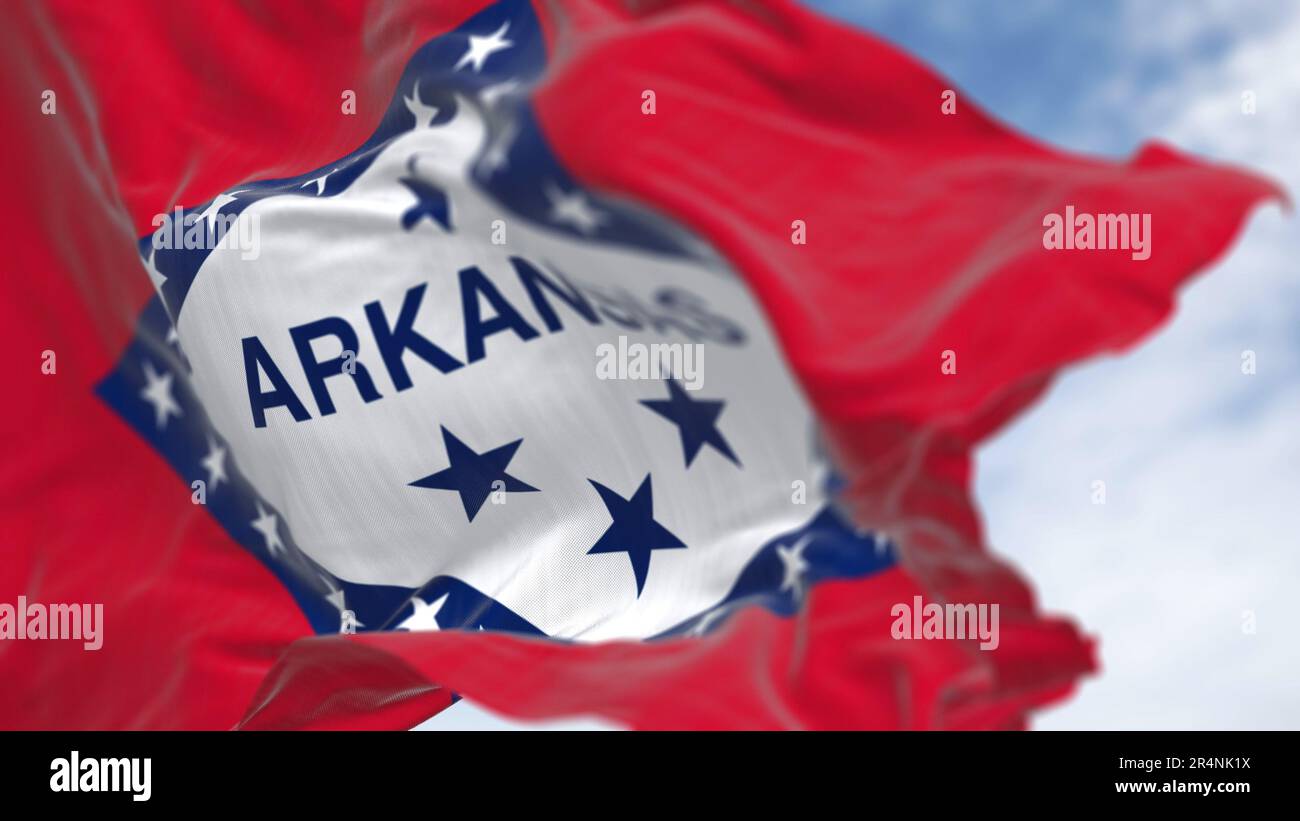 Arkansas state flag waving in the wind on a clear day. Red field with ...