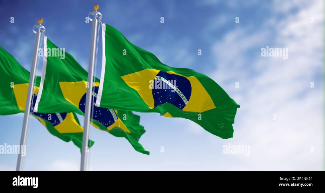 Three Brazil national flags waving on a clear day. Yellow diamond on ...