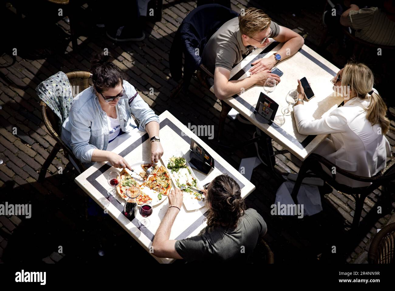 UTRECHT - Day trippers sit on the terrace on Whit Monday. Many people ...