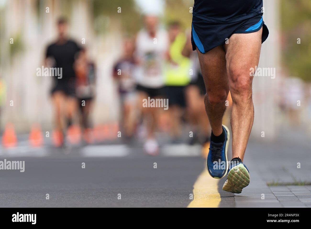 Marathon runners running on city road, large group of runners Stock ...