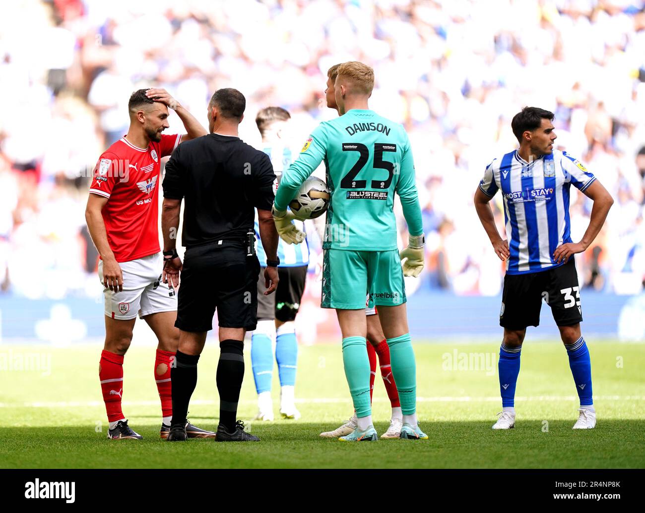 Barnsley's Adam Phillips (left) reacts after being shown a red card for ...