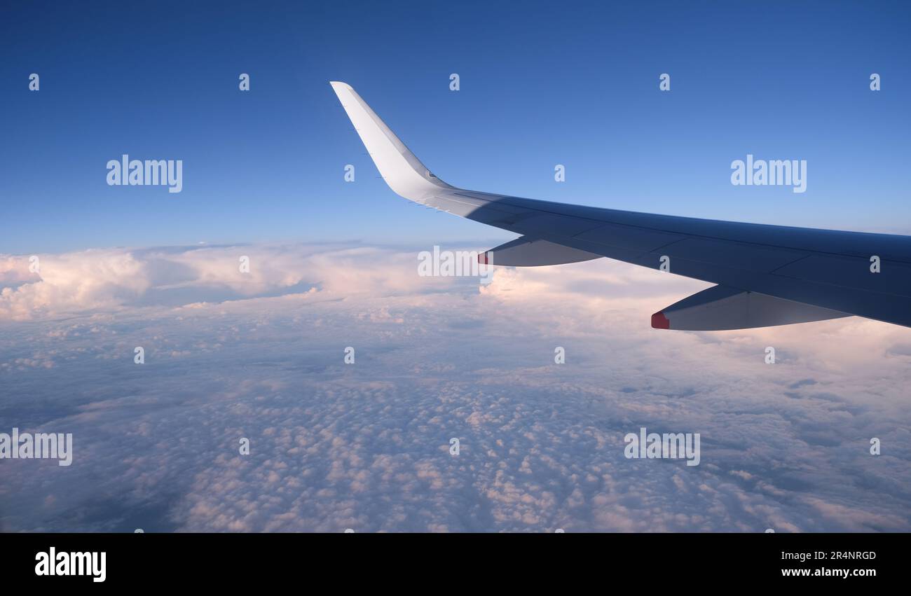 Airplane in flight above cloudy sky . Aerial top view from air wing ...