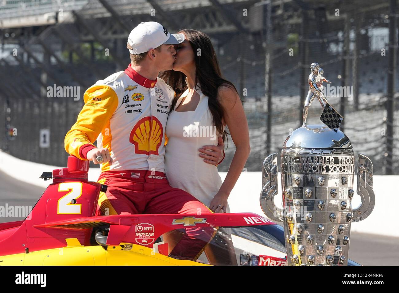 Josef Newgarden kisses his wife, Ashley, as they pose with the Borg ...