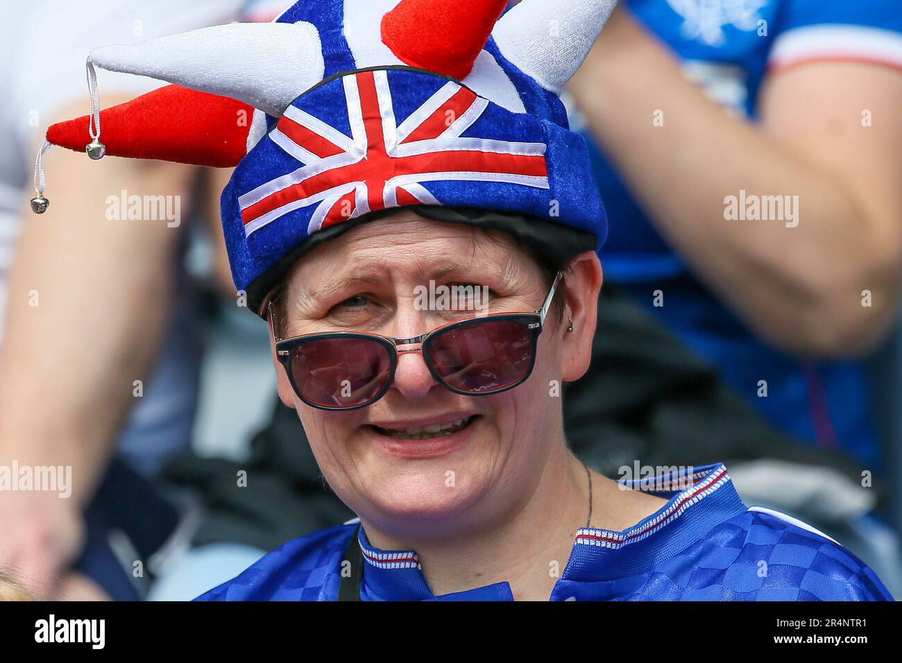 Woman dressed in Rad, white and blue, the colours of rangers fc, while ...