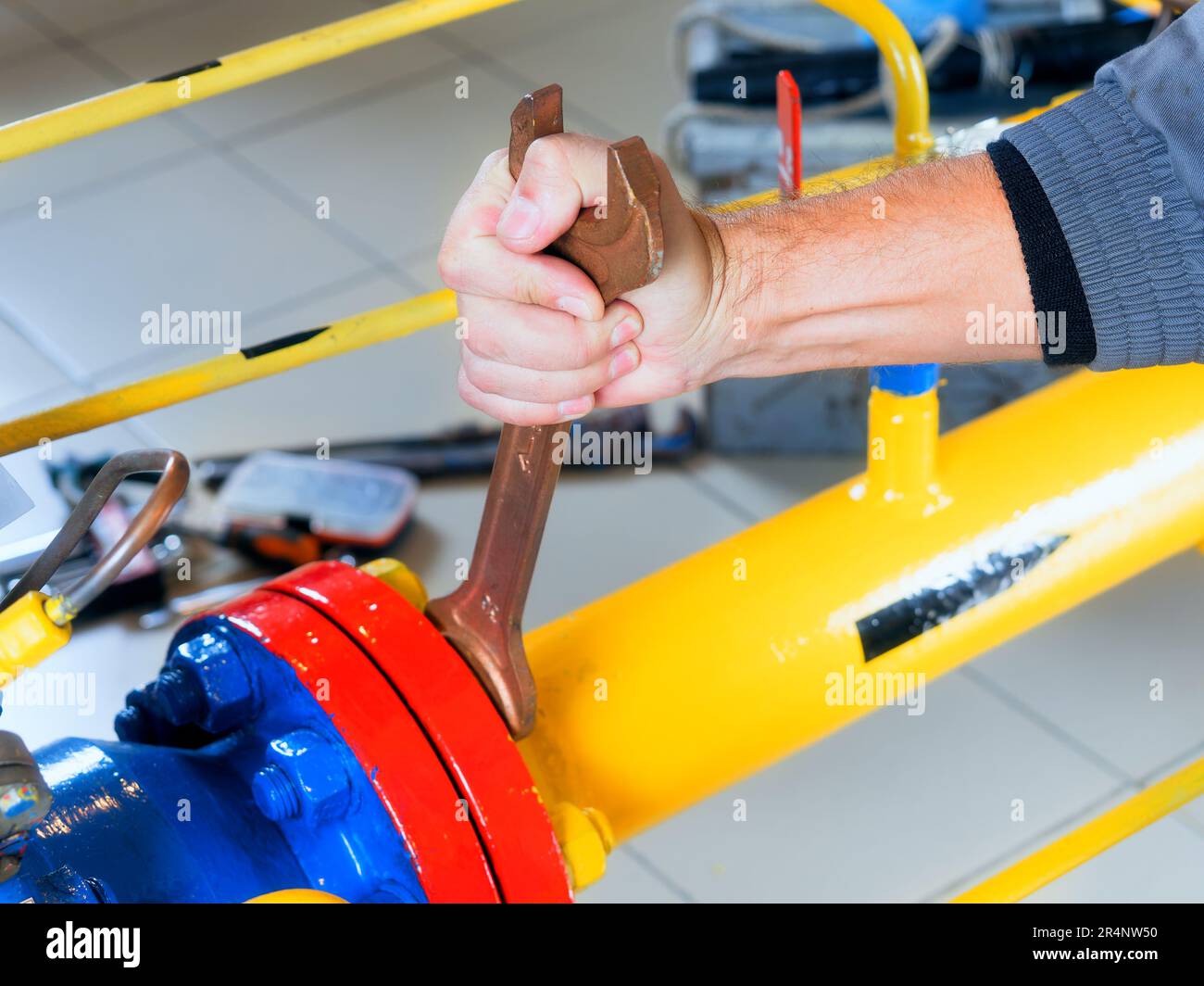 The worker tightens the nut of the gas equipment with an adjustable ...