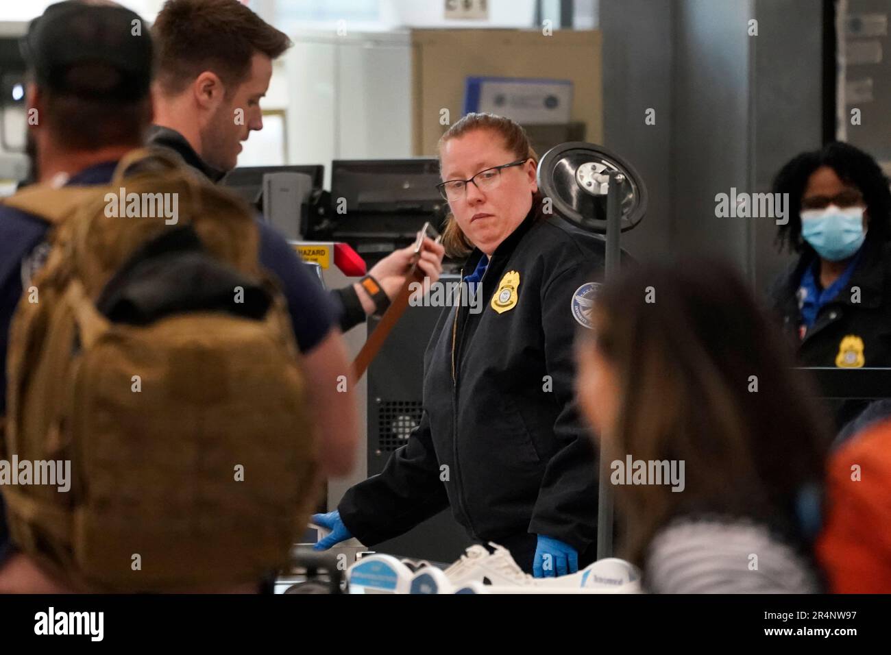 A TSA agent looks over a security checkpoint at Chicago's O'Hare ...