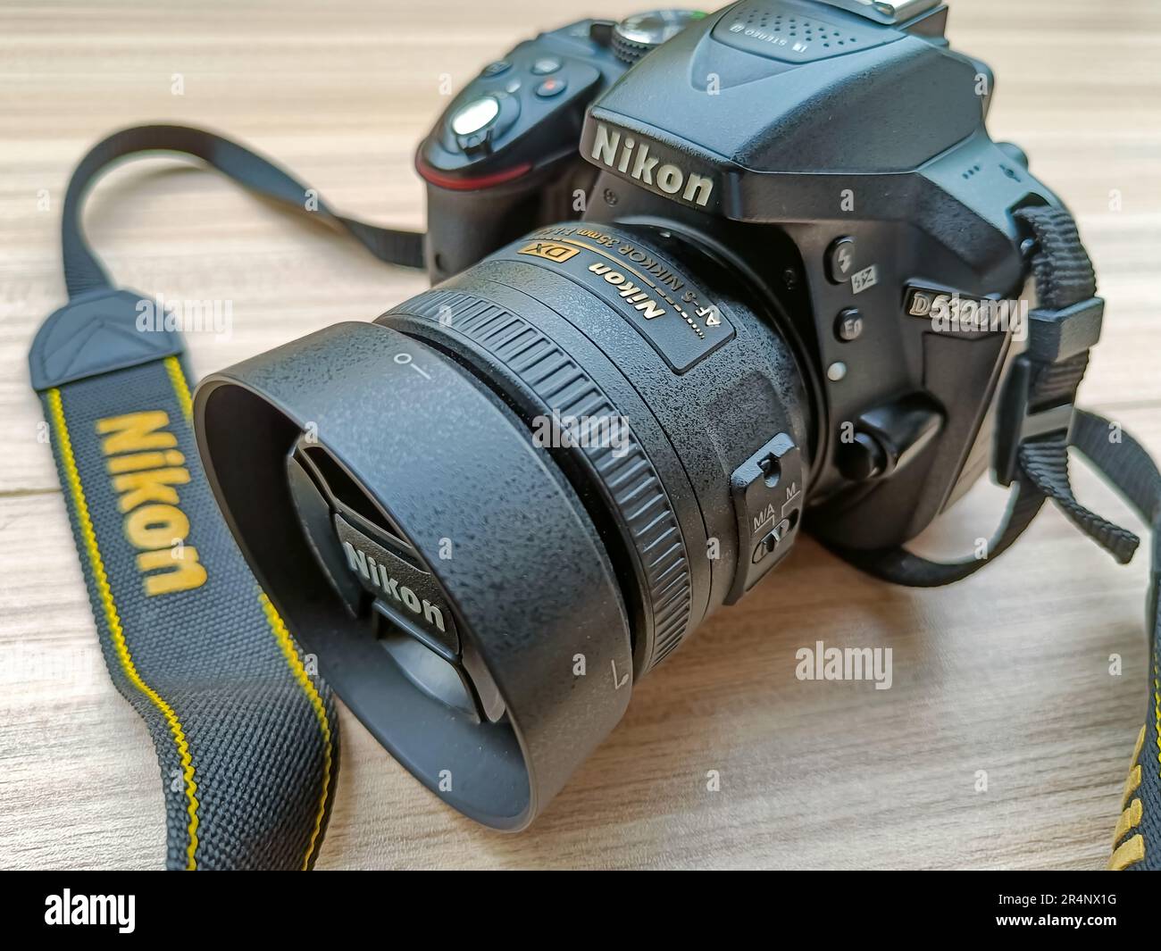 New Delhi, India, May 28 2028 - Nikon D5300 camera with 35mm f2.8 prime lens on plain background ...