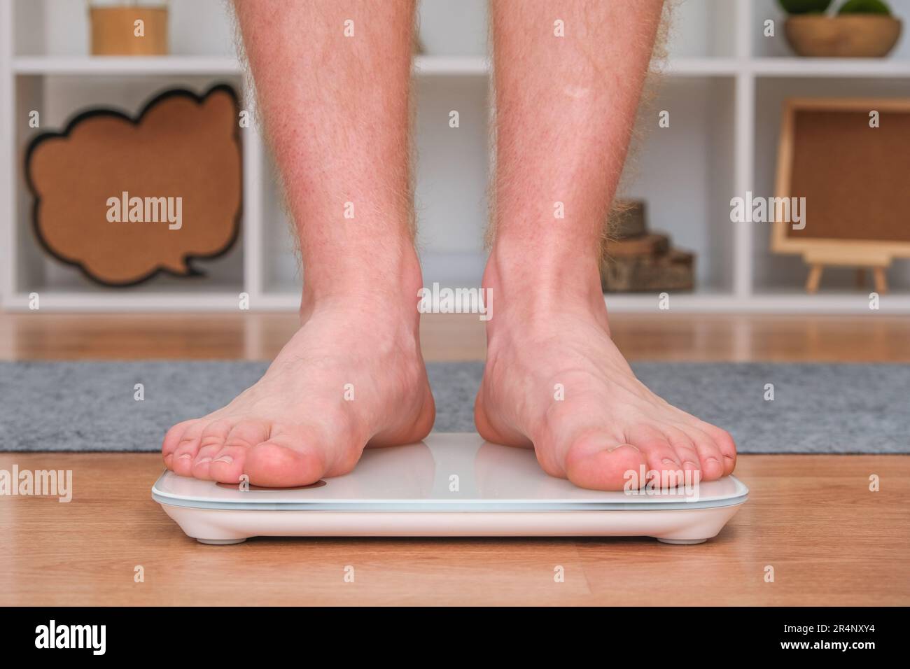 Man weighing himself on the scales hi-res stock photography and images ...