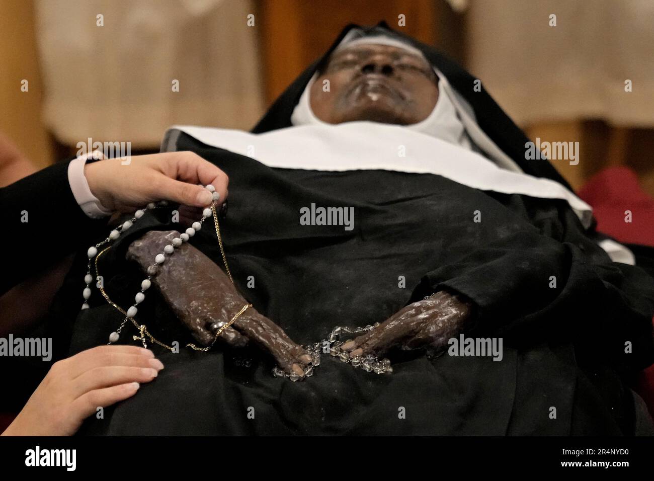 People pray over the body of Sister Wilhelmina Lancaster at the ...