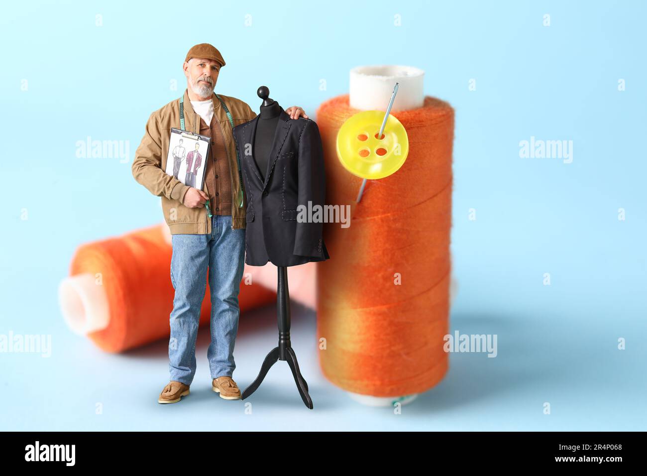 Small mature clothes designer with sketches, mannequin and big threads ...
