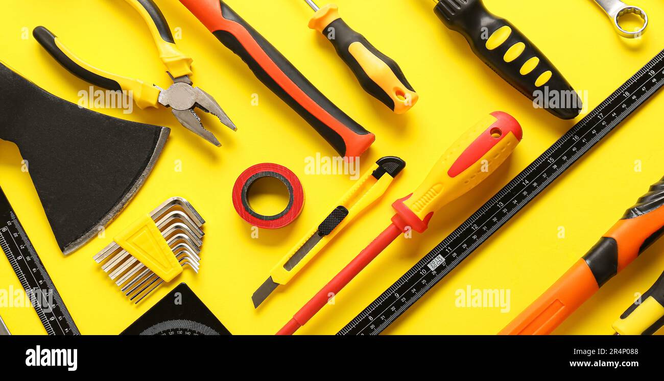 Set of construction tools on yellow background Stock Photo - Alamy