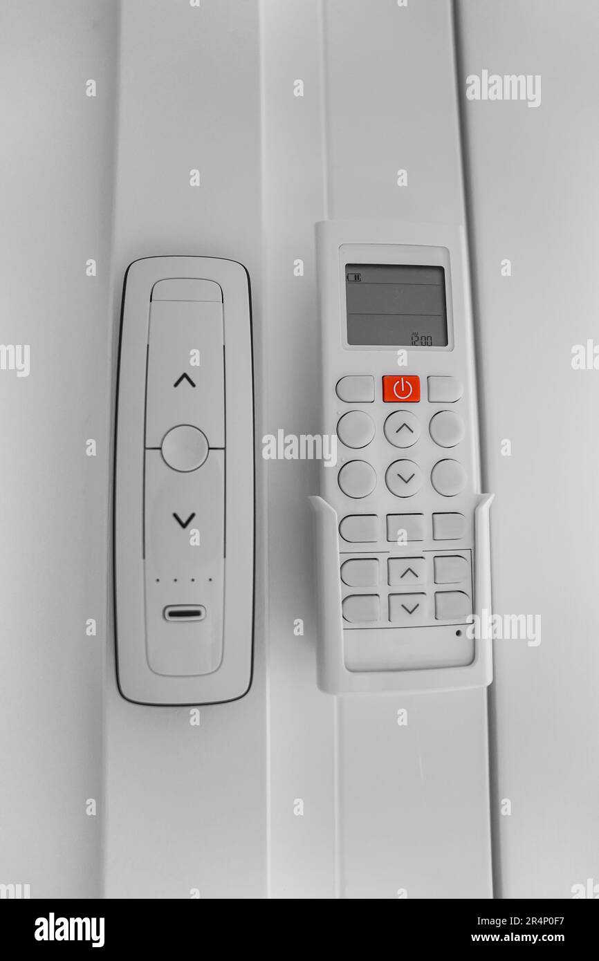 Air conditioner's remote control on light wall in room Stock Photo - Alamy