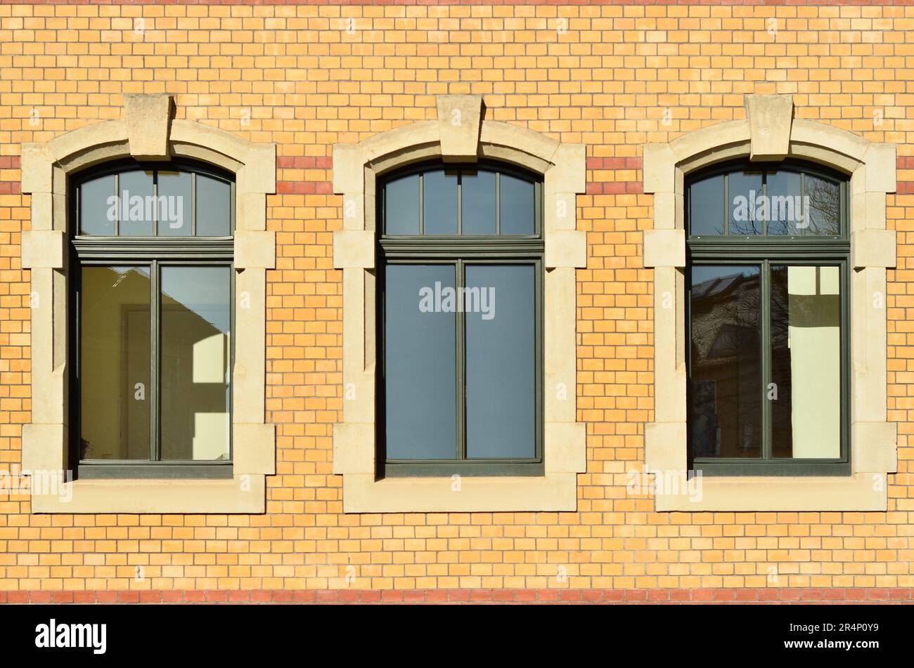 View of brick building with wooden windows Stock Photo - Alamy