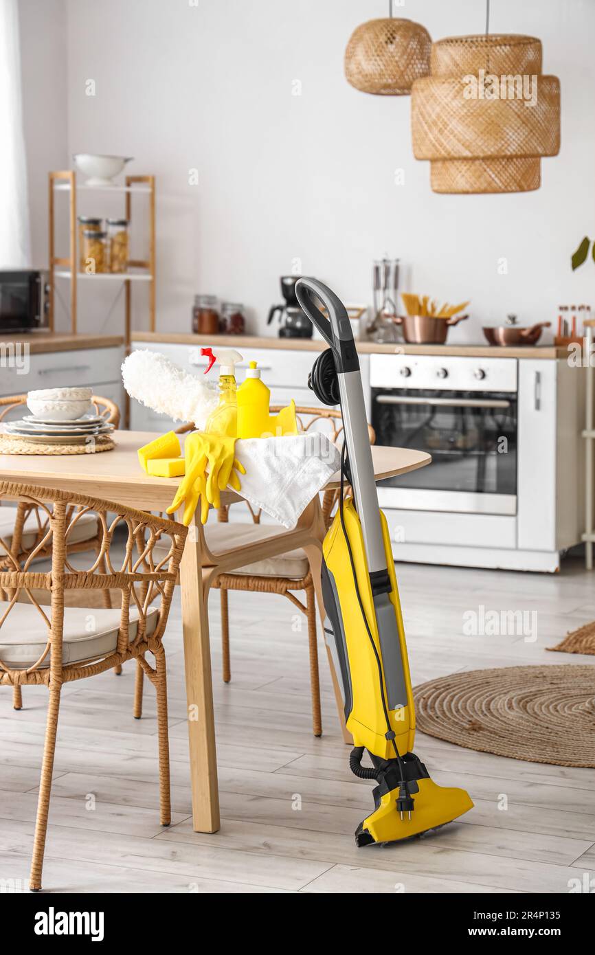 Cleaning supplies on dining table in kitchen Stock Photo - Alamy