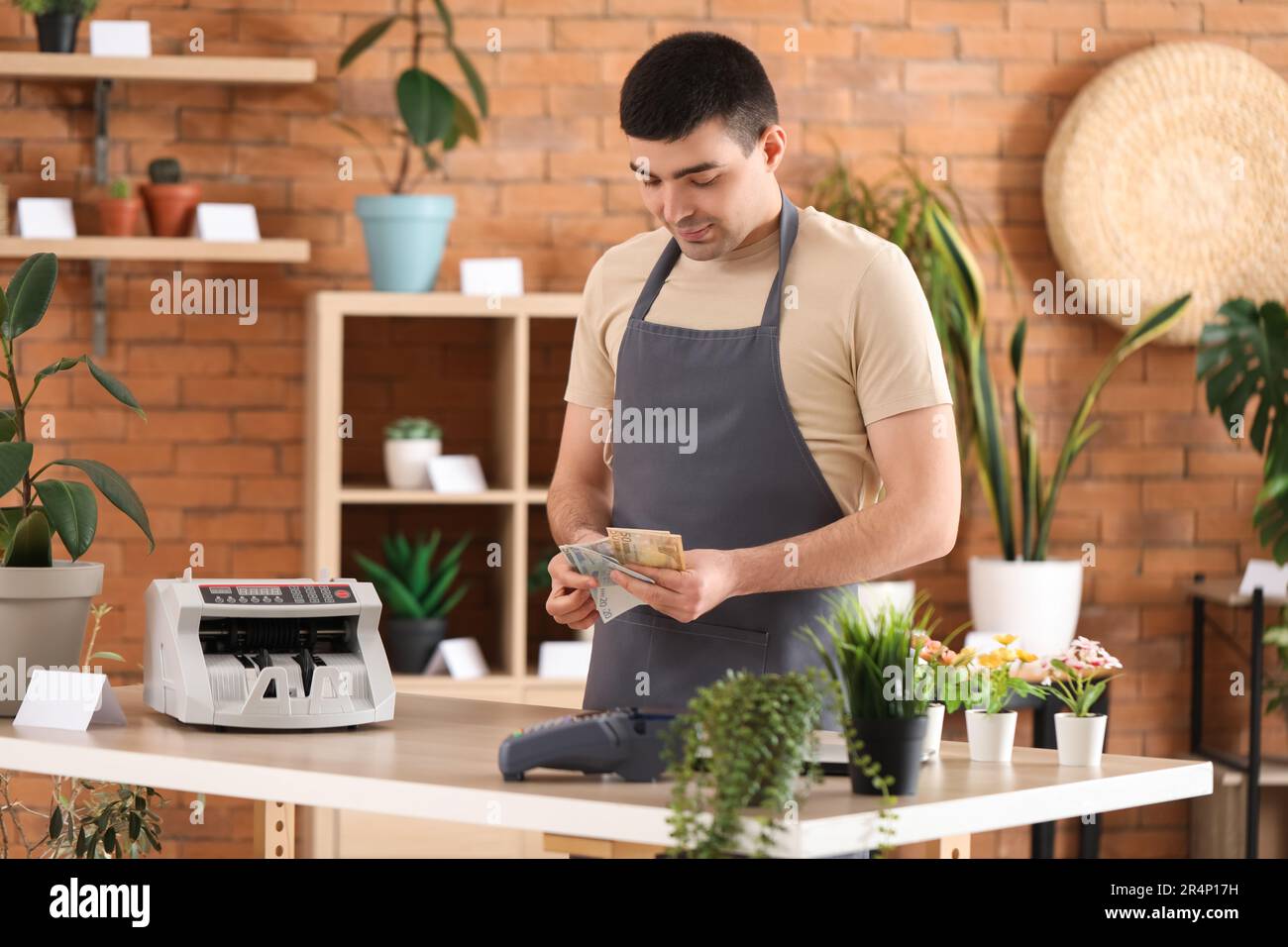 Male cashier hi-res stock photography and images - Alamy