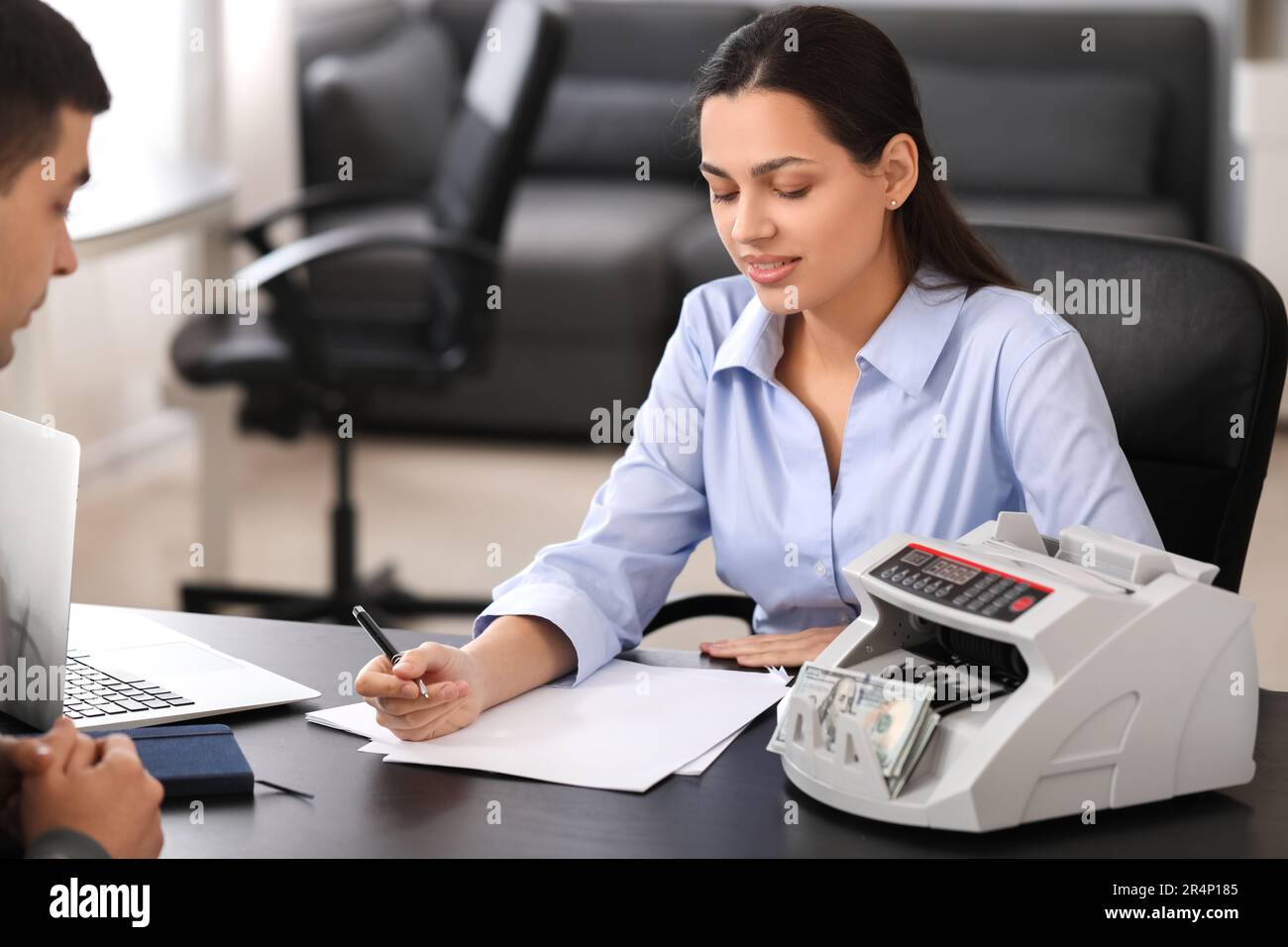 Female bank manager working with client in office Stock Photo - Alamy