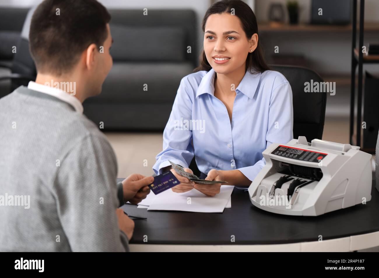 Female bank manager working with client in office Stock Photo - Alamy