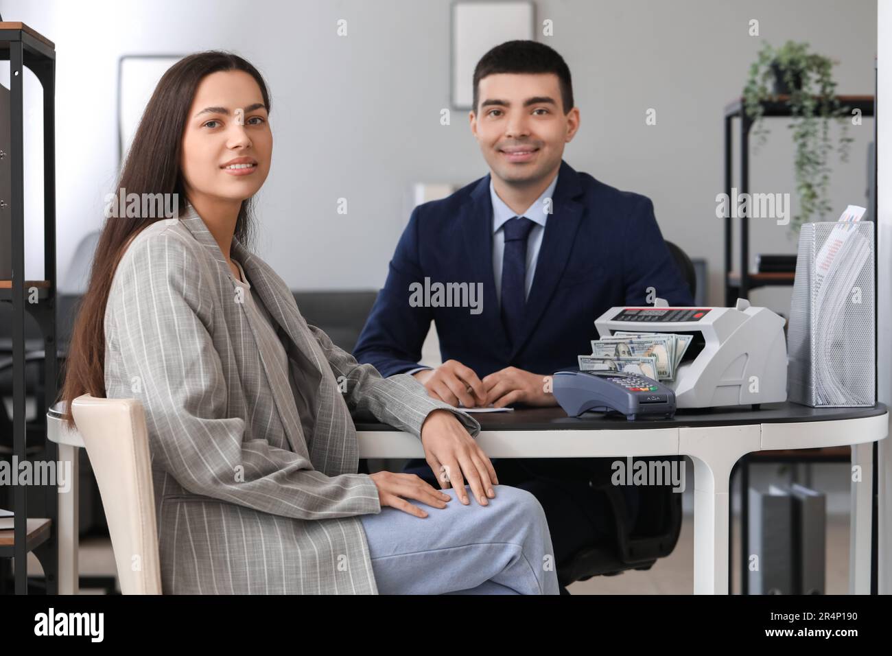 Male bank manager working with client in office Stock Photo - Alamy