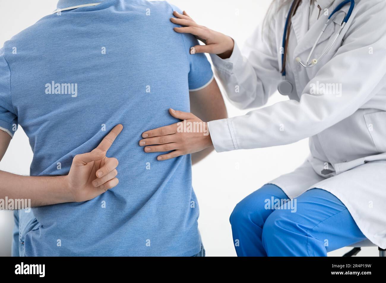 Female doctor checking posture of young man in clinic, closeup Stock ...